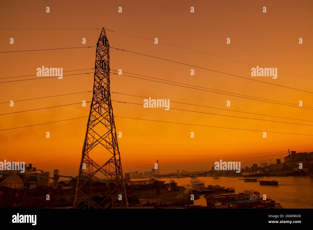High Voltage electric pylons with colorful landscapes after sunset ...