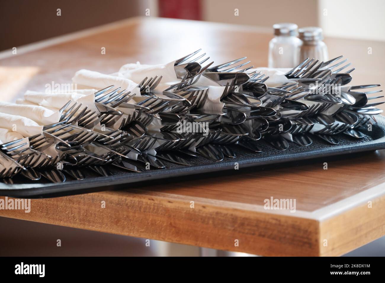 On Tray On Table Are Prepared Sets Of Eating Utensils - Knifes And ...