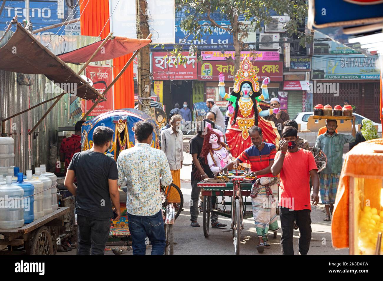 Narayanganj, Dhaka, Bangladesh. 23rd Oct, 2022. Devotees transport an ...