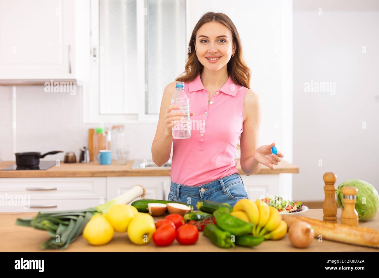 Woman drinking water kitchen hi-res stock photography and images - Alamy
