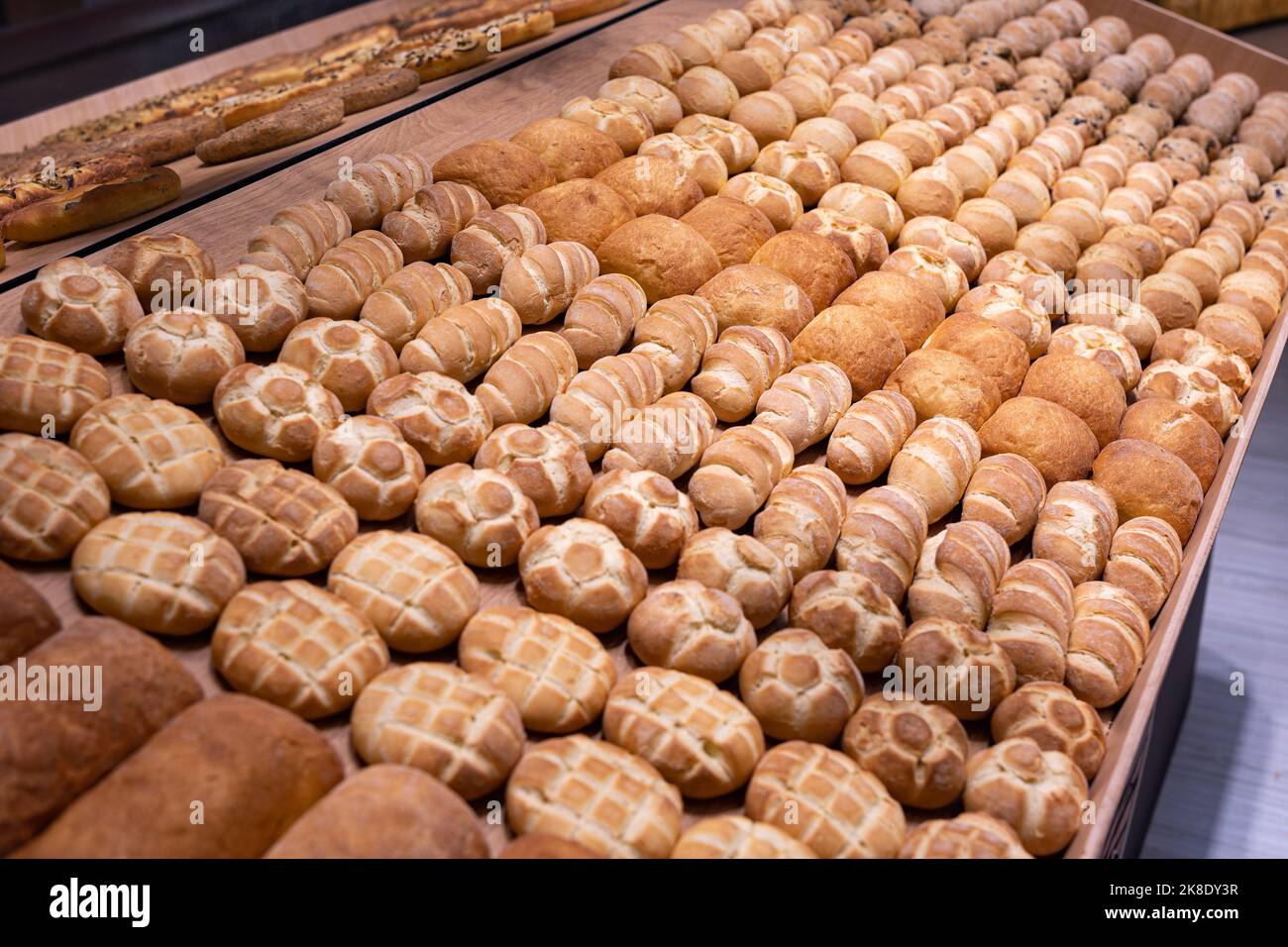 Various Types of Bread Buns displayed Orderly on Top of a Wooden ...