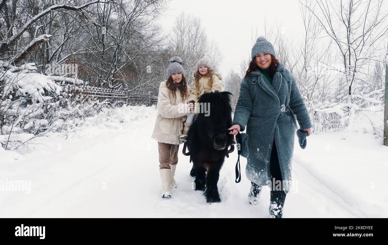 winter horse ride. horseback riding at winter. family horseback ride on ...