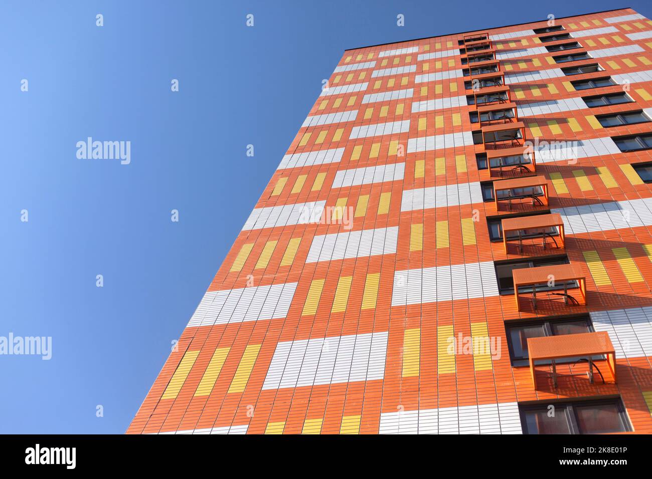 Orange building in modern style. House with identical windows. Lot of ...