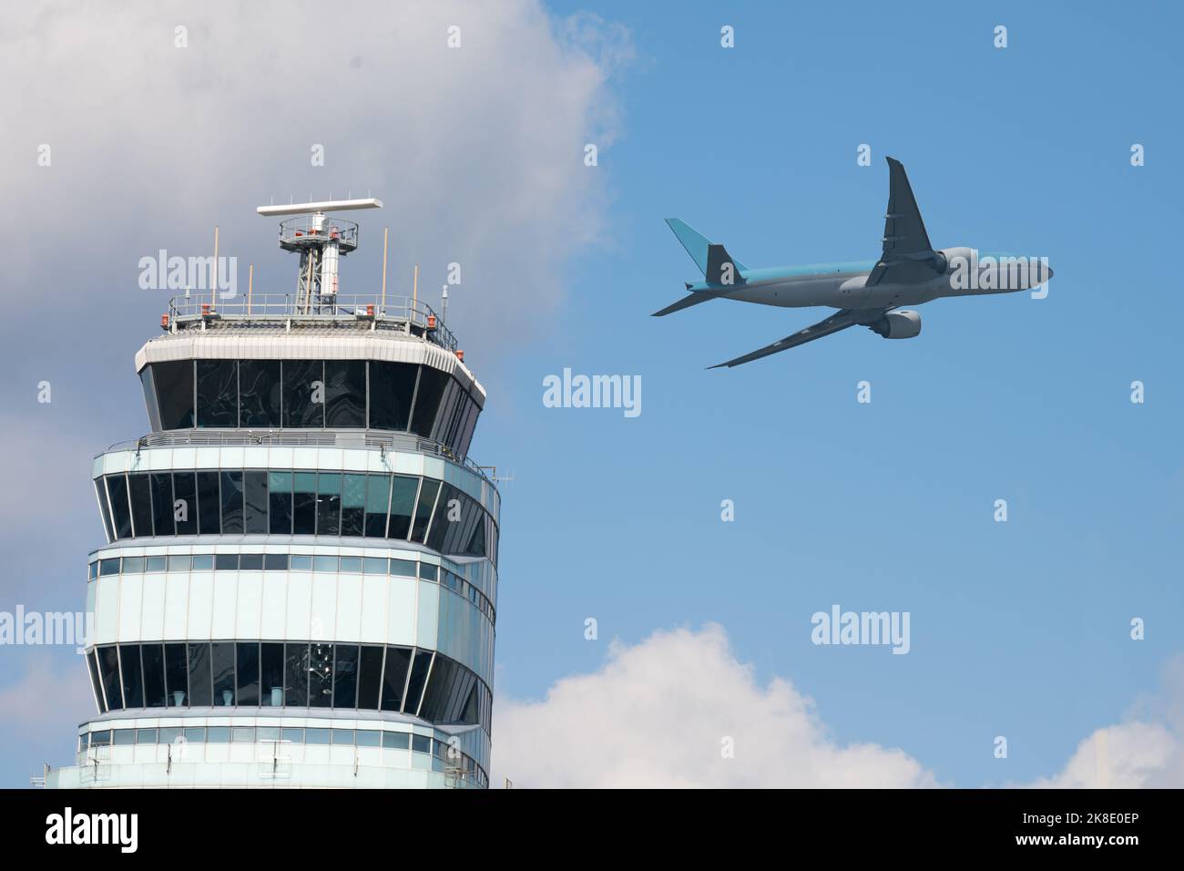 Airport radio tower in front of partly cloudy sky with departing ...