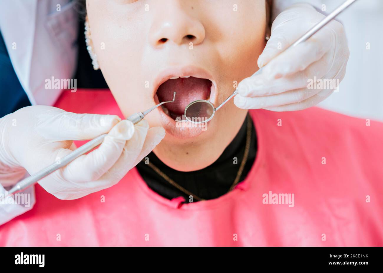Dentist checking patient mouth with dental mirror. Close-up of patient ...
