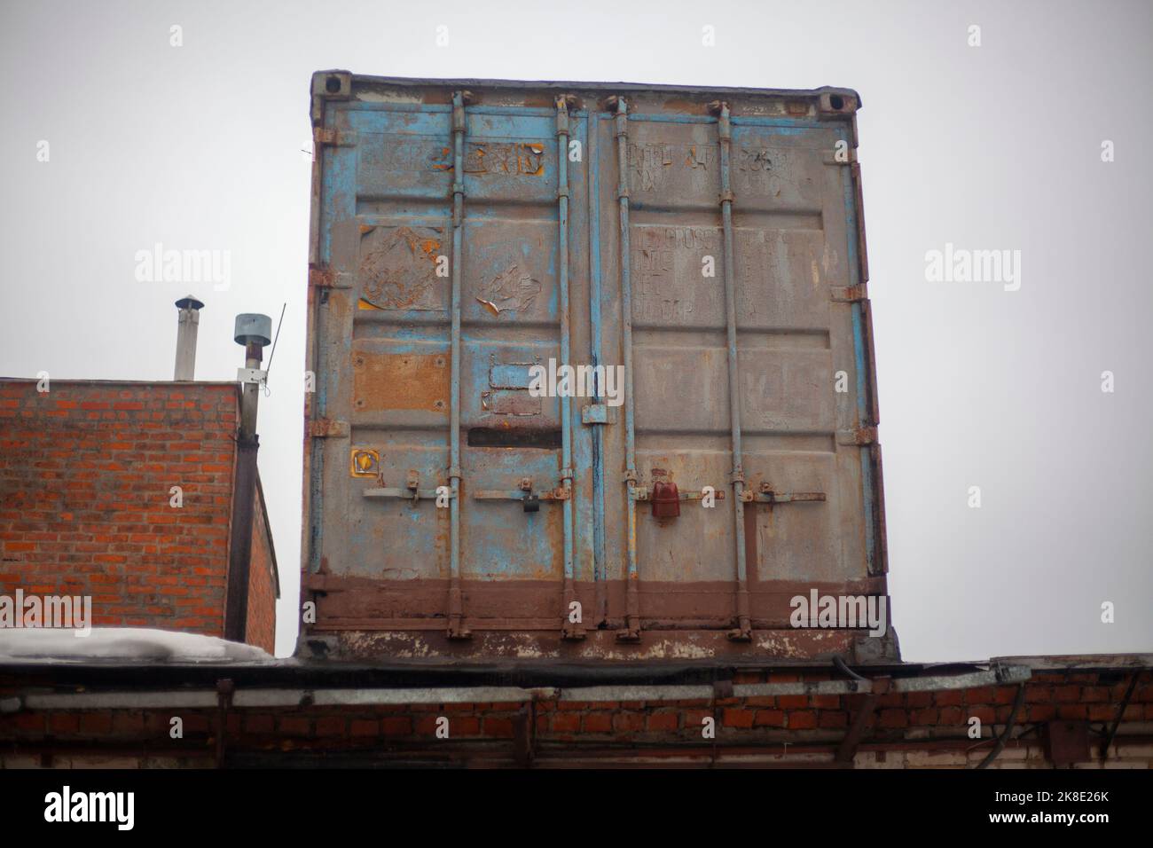 Container on roof. Steel container from stock. Old box. Gates with ...
