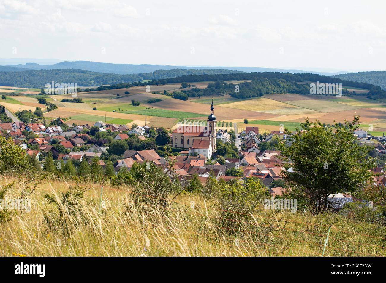 Duensberg Oberelsbach Dry grassland in front of village and grey sky ...