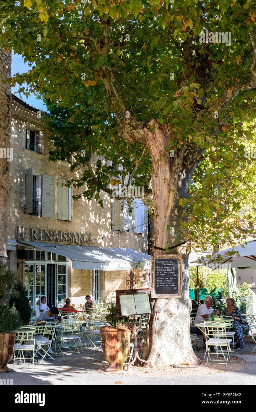 People sitting at a restaurant/cafe under a tree in Gordes, Provence ...