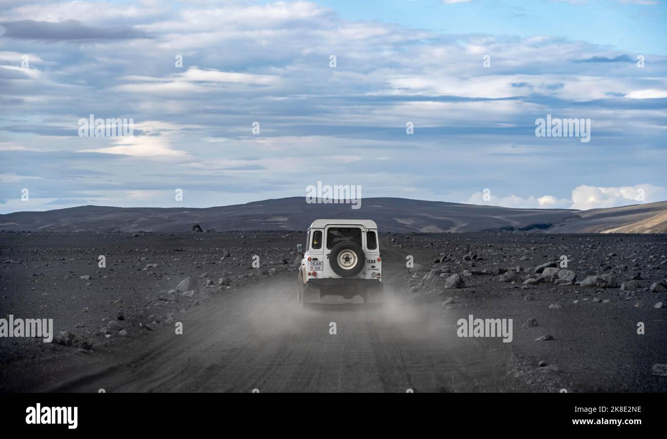 White Land Rover on a dirt road, volcanic landscape, barren landscape ...