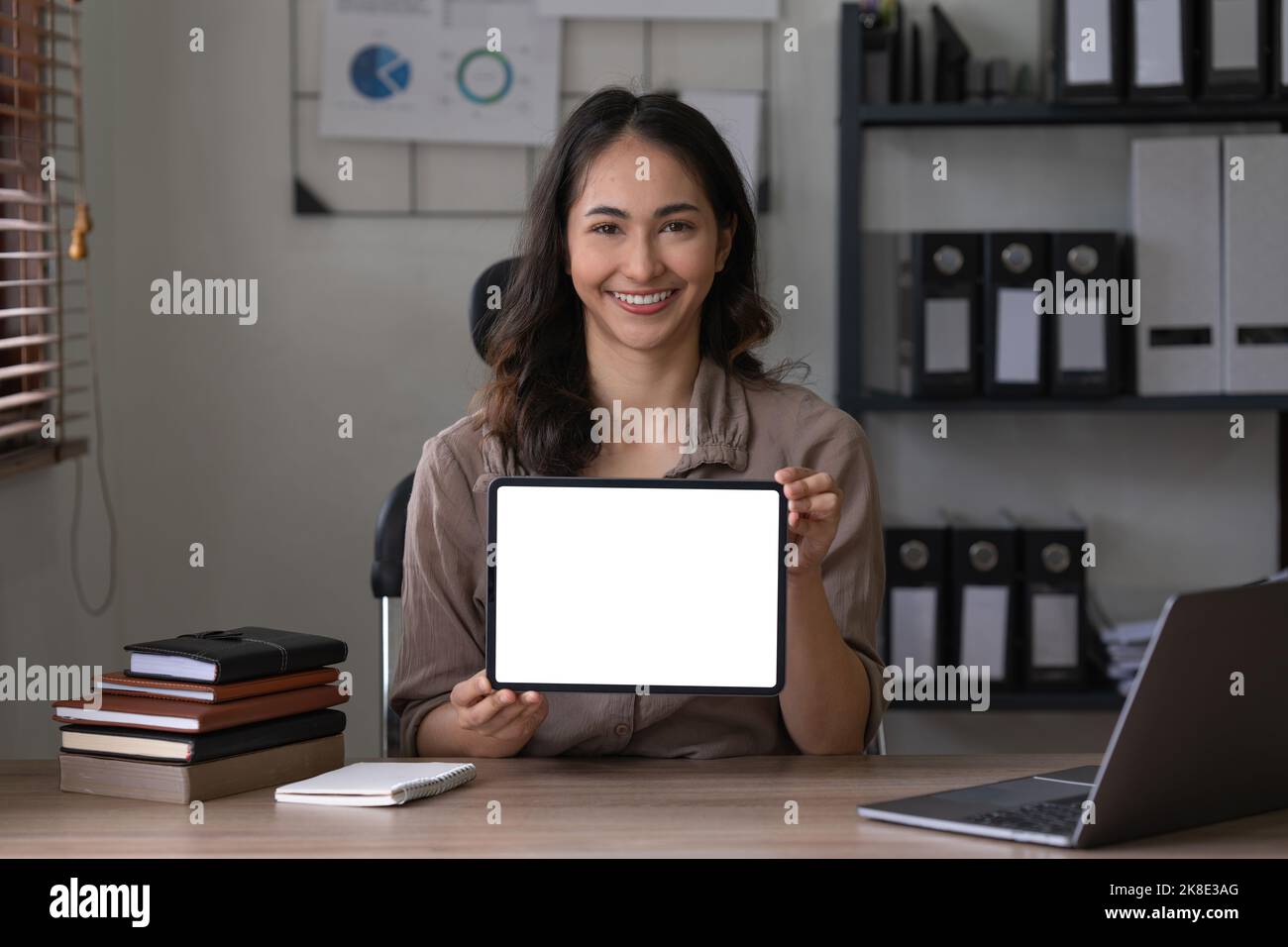 Business woman holding digital tablet show something on display at ...