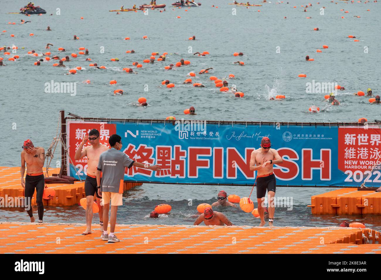 Participants cross the finish line during the annual swimming ...