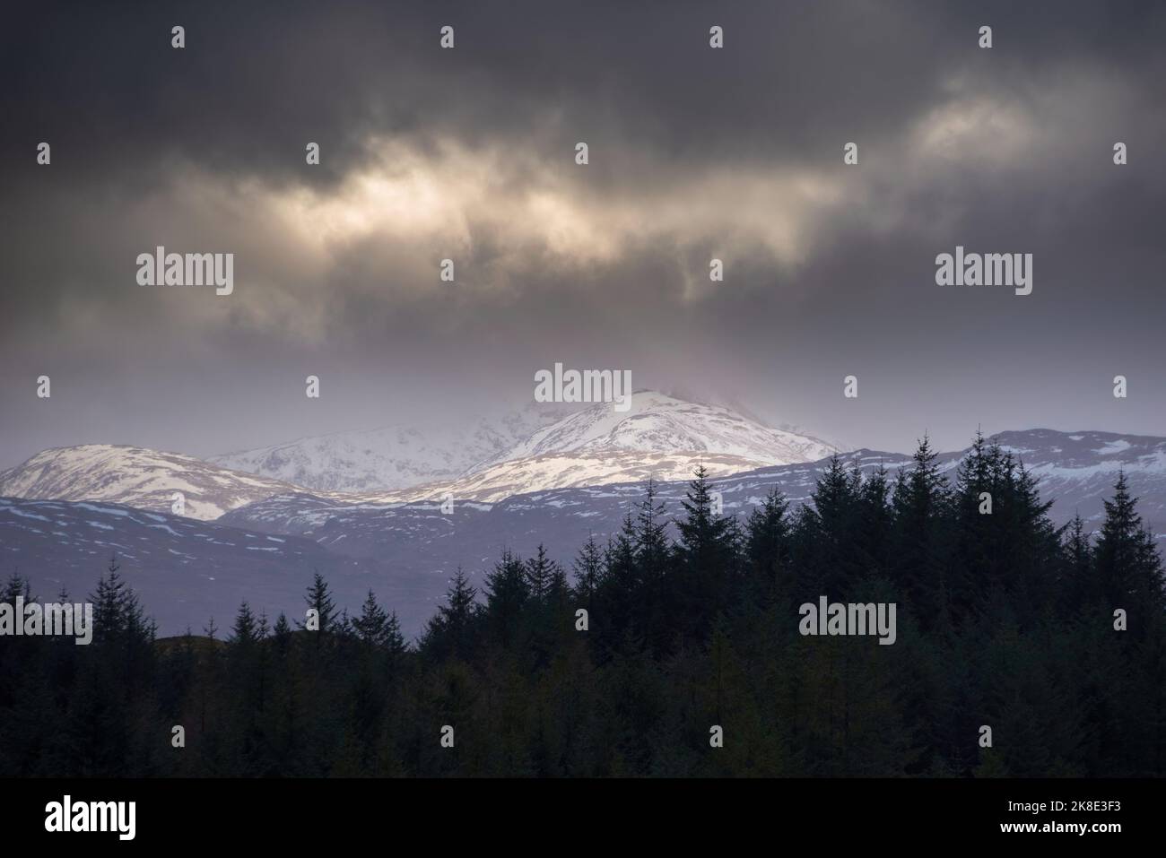 Landscape image of dramatic Winter storm sunset clouds over the peaks ...
