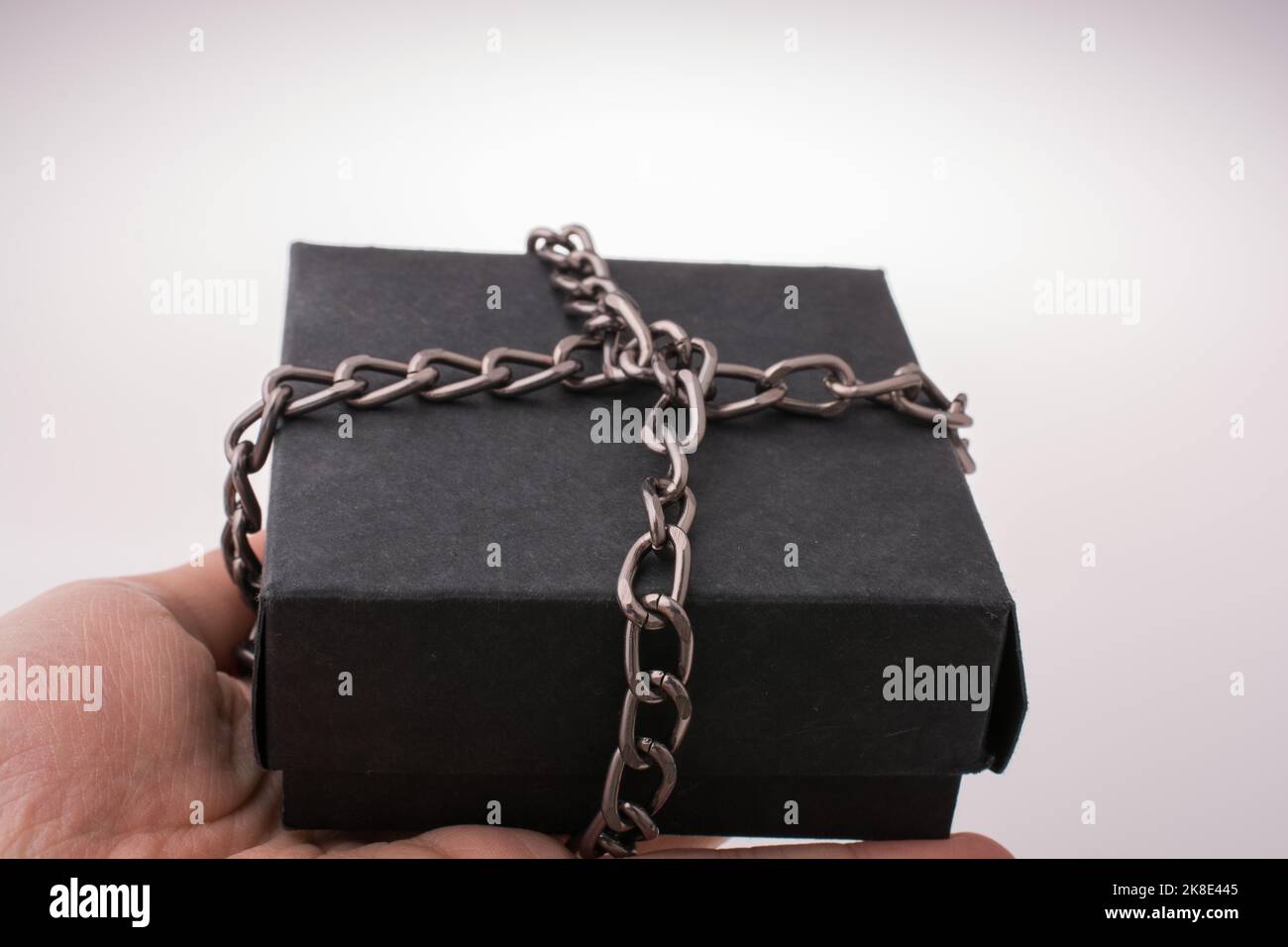 Gift box of black color on brown background Stock Photo - Alamy