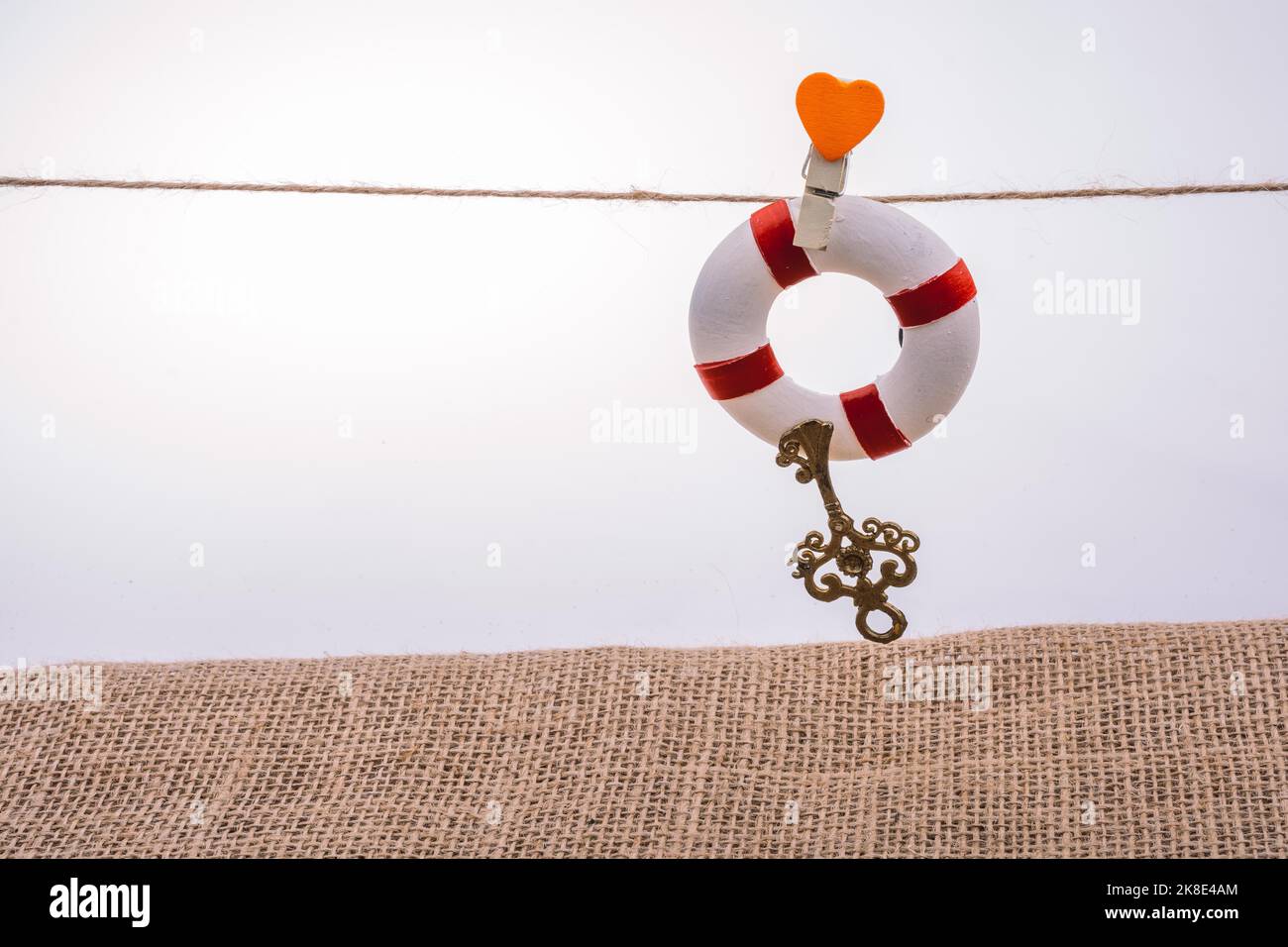 Life preserver attached to a string with heart icon Stock Photo - Alamy