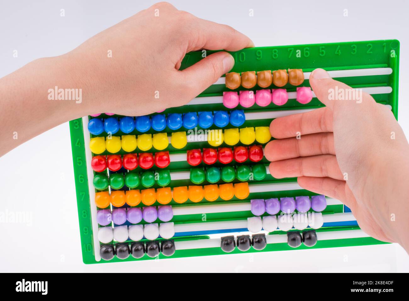 Hand using a color abacus Stock Photo - Alamy