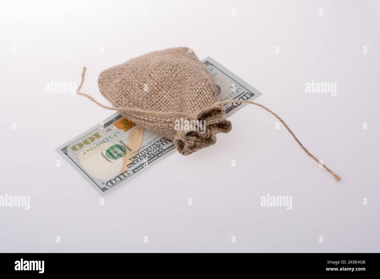 Banknote of US dollar placed under a linen sack Stock Photo - Alamy
