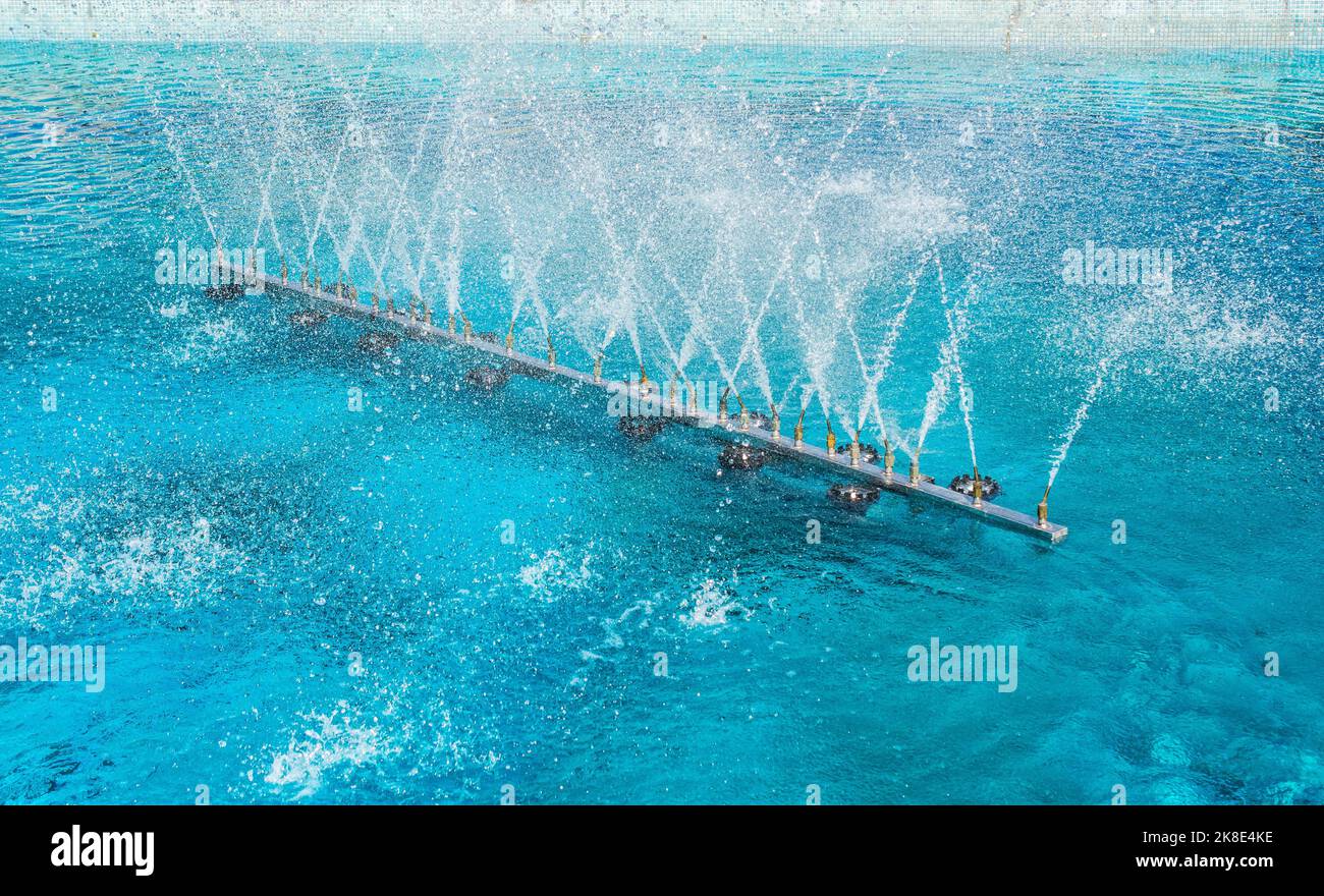 A water fountain sprinkling water in the view Stock Photo - Alamy