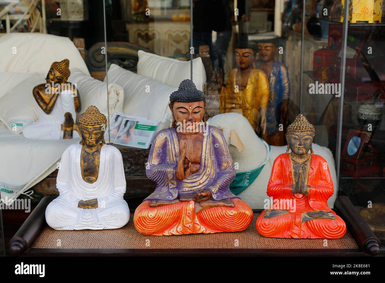 Window display of a bed house, Buddhas, pillows in the back, blankets ...