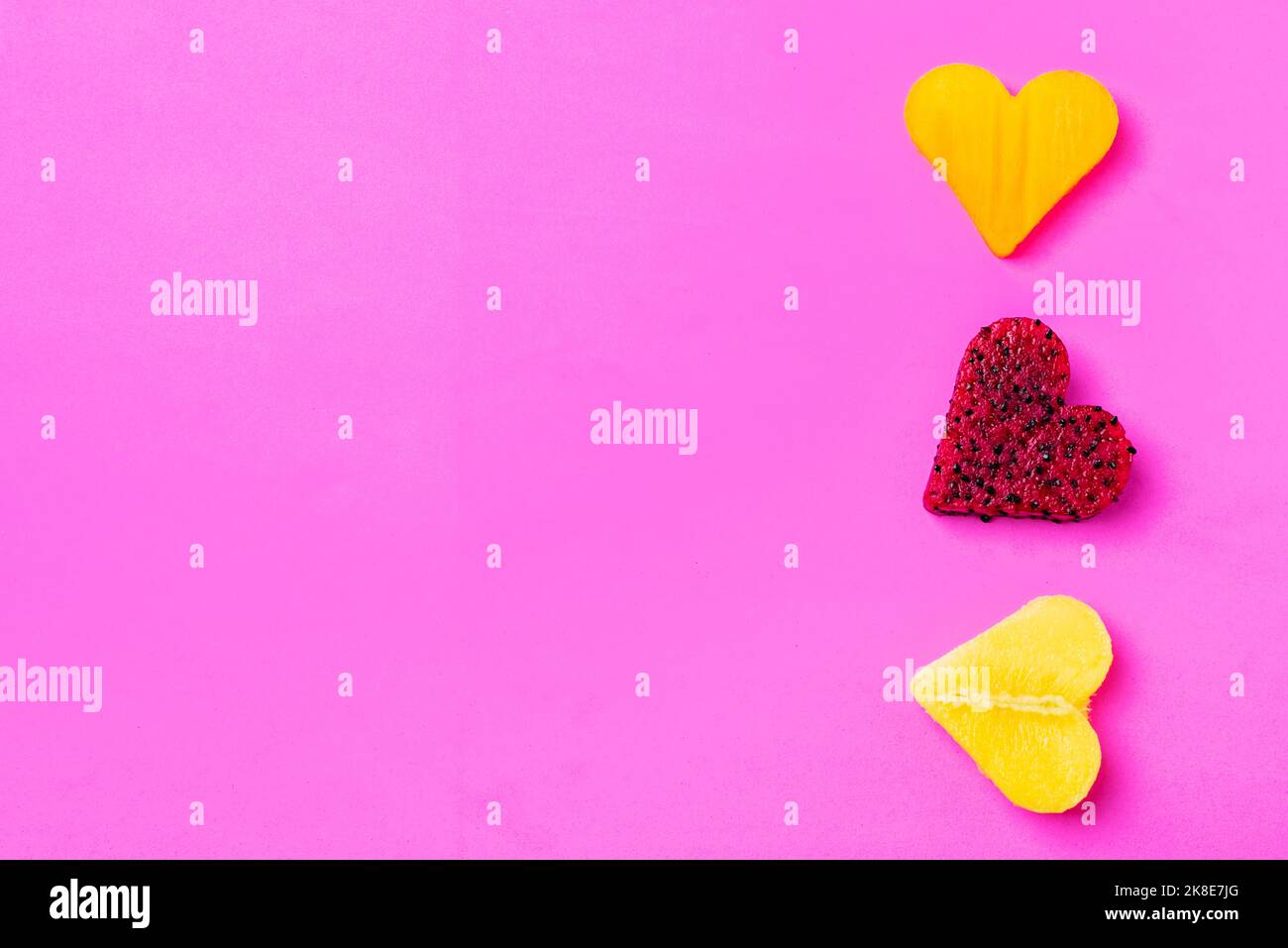 Three pieces of tropical fruits such as pitahaya,mango and a heart ...