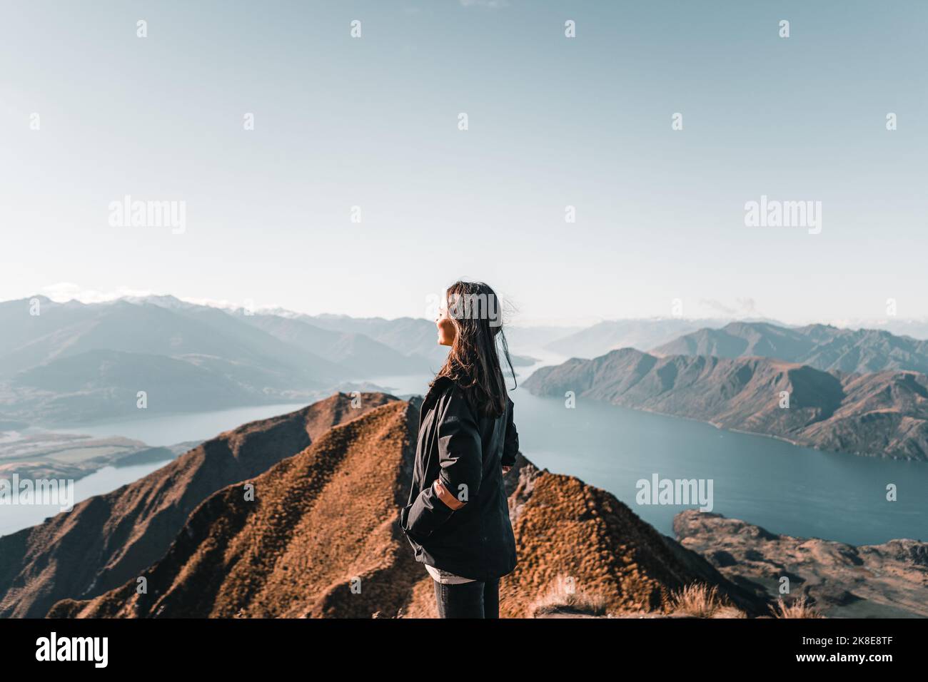brunette caucasian girl with long hair with sunlit face standing in ...