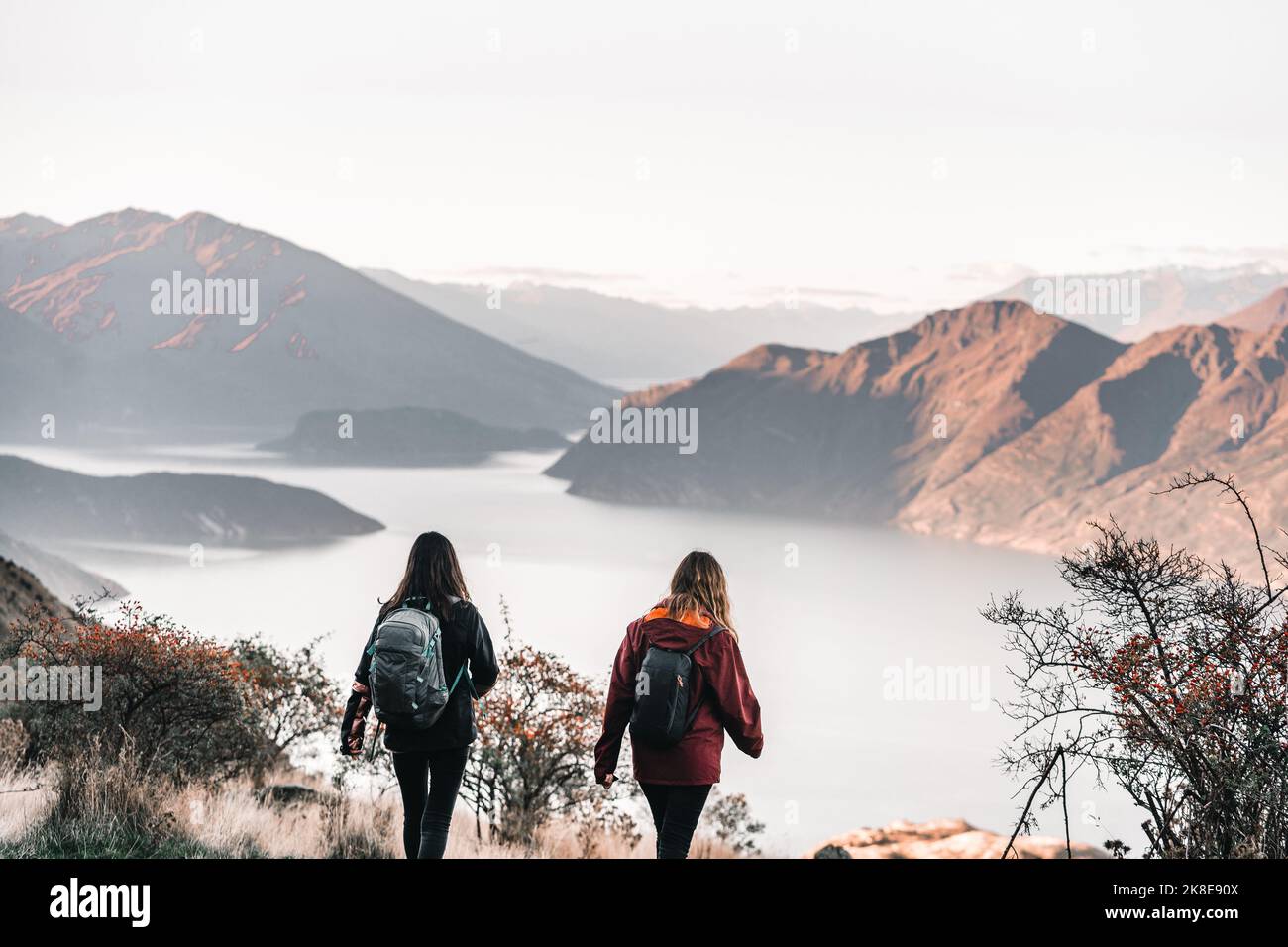 two caucasian girls, one blonde and one brunette, warm with jackets and ...