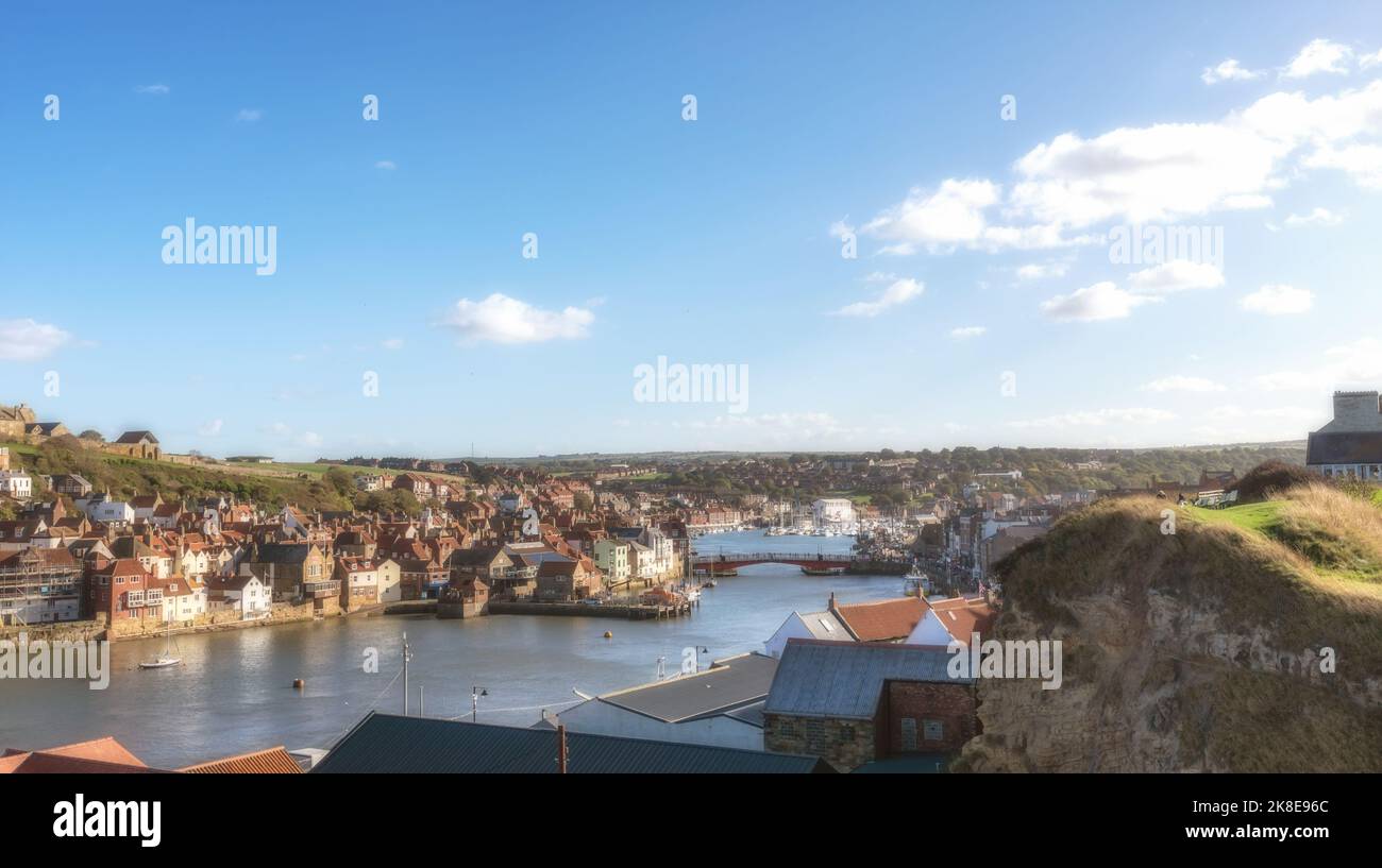 Panorama of the harbour and town of Whitby. A cliff is in the ...