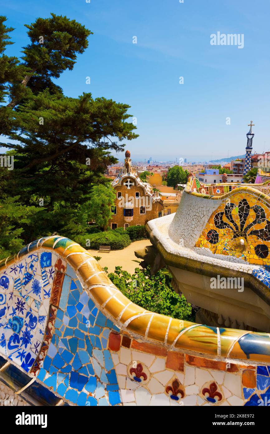 Barcelona. Ceramic bench and buildings in the Park Guell designed by ...