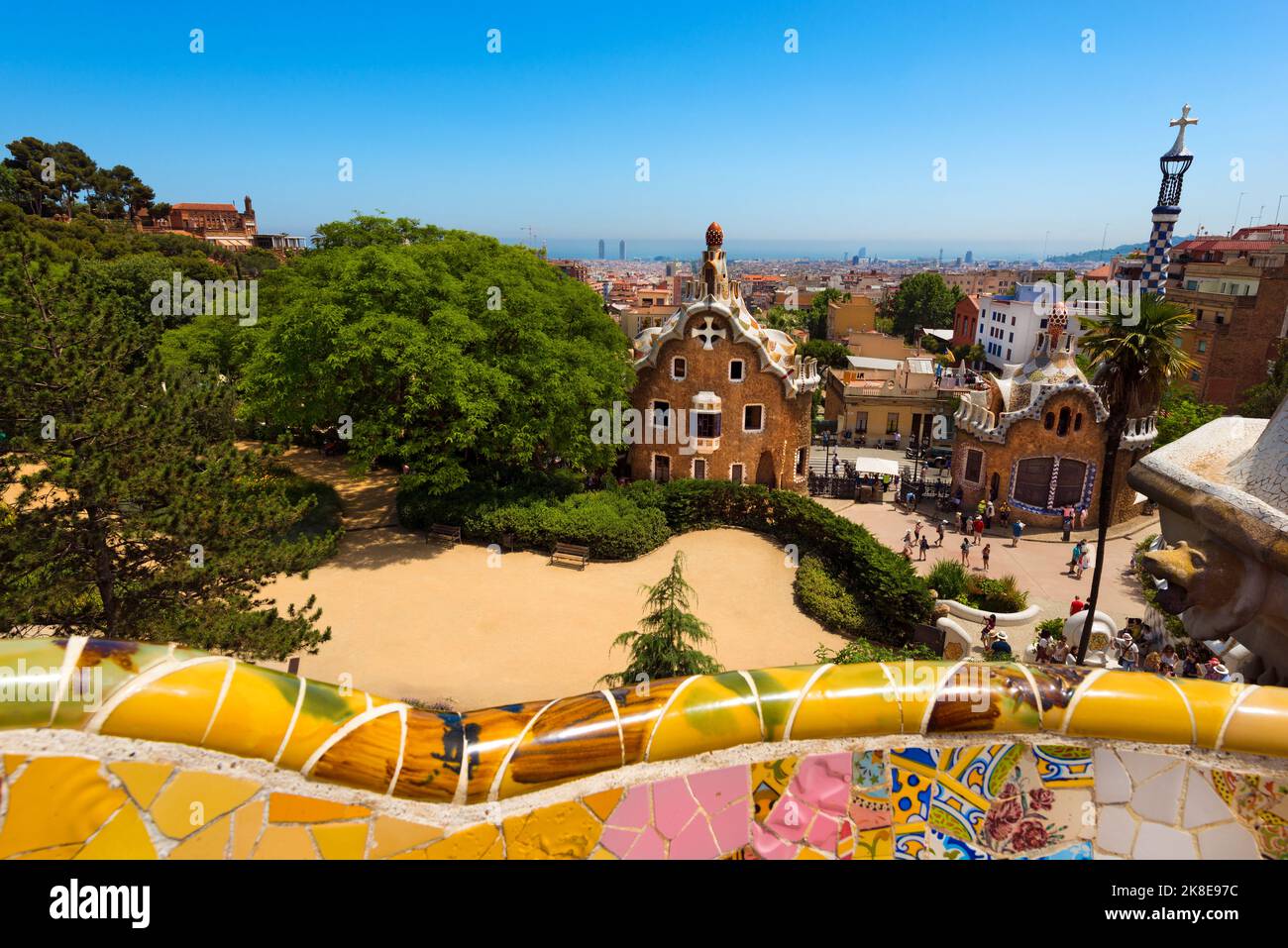 Barcelona. Ceramic bench and buildings in the Park Guell designed by ...