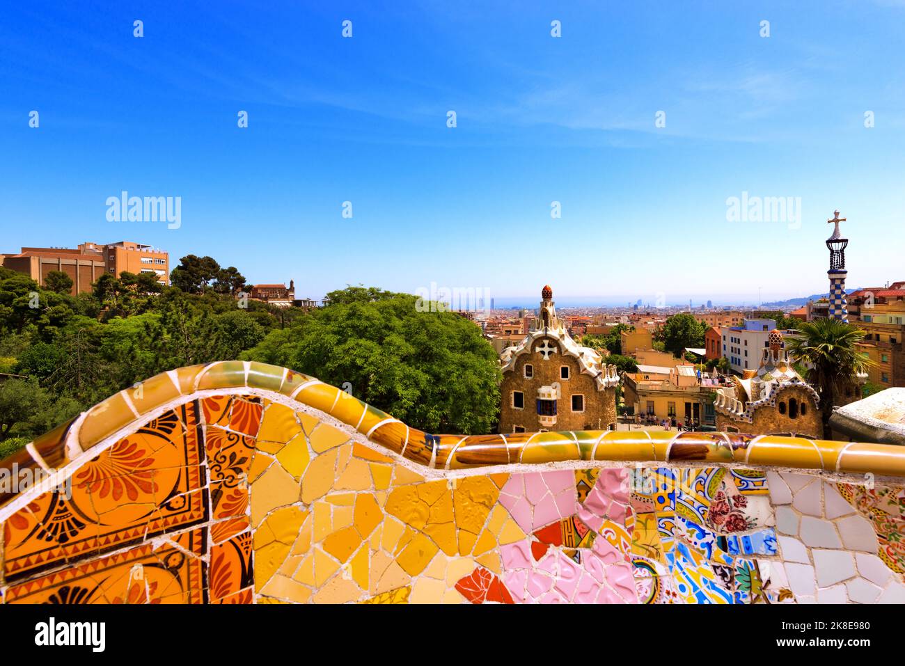 Barcelona. Ceramic bench and buildings in the Park Guell designed by ...