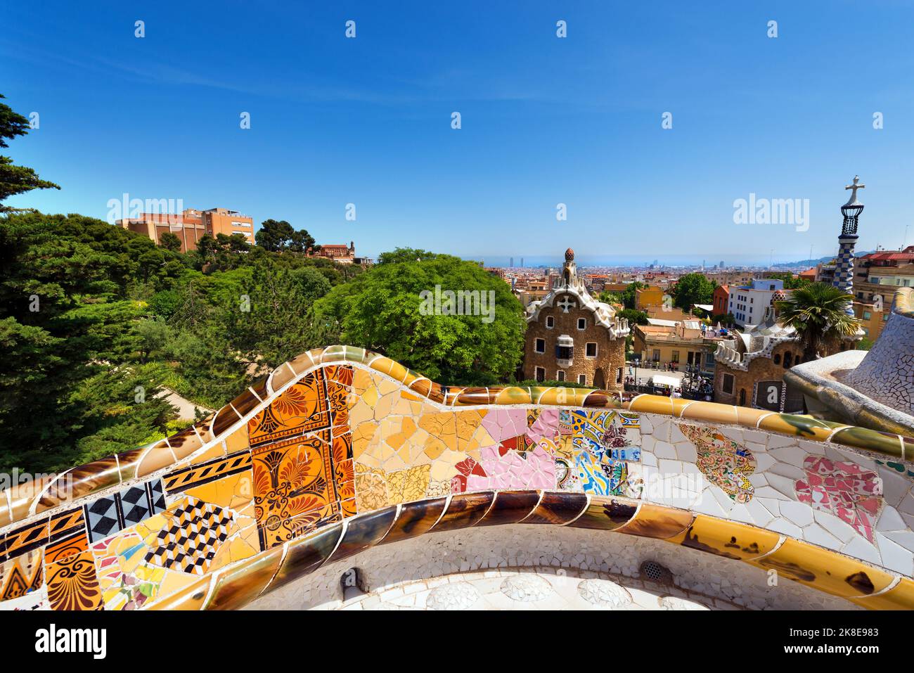 Barcelona. Ceramic bench and buildings in the Park Guell designed by ...