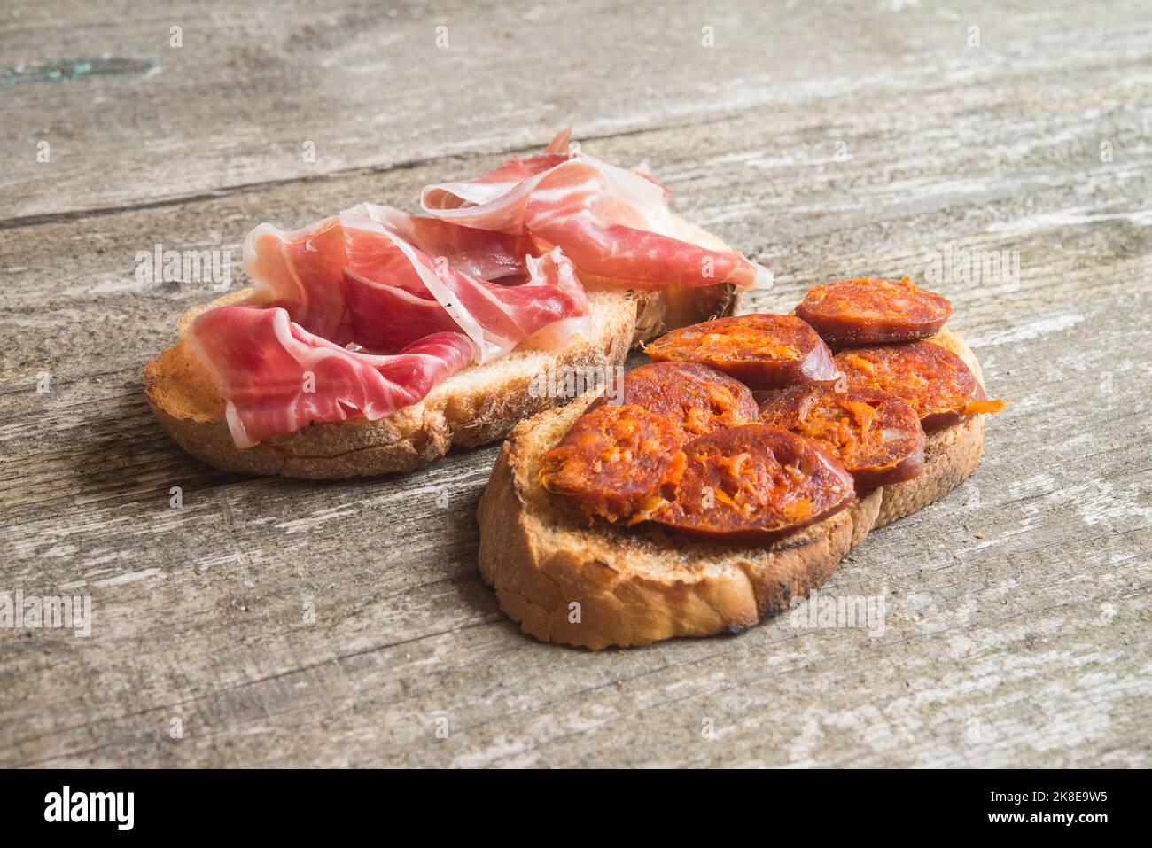bread toast with chorizo and ham (spanish tapa Stock Photo - Alamy