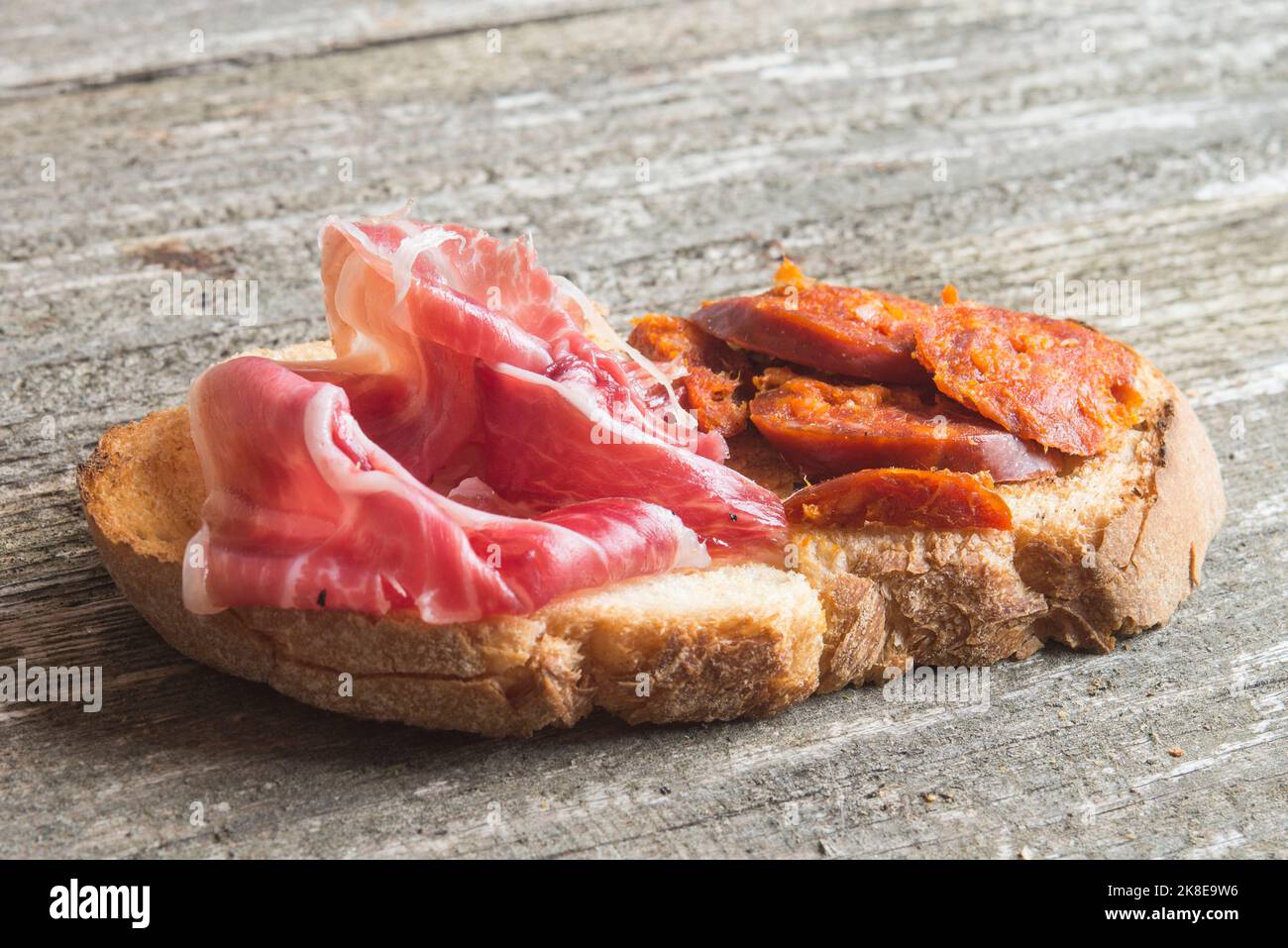 bread toast with chorizo and ham (spanish tapa Stock Photo - Alamy