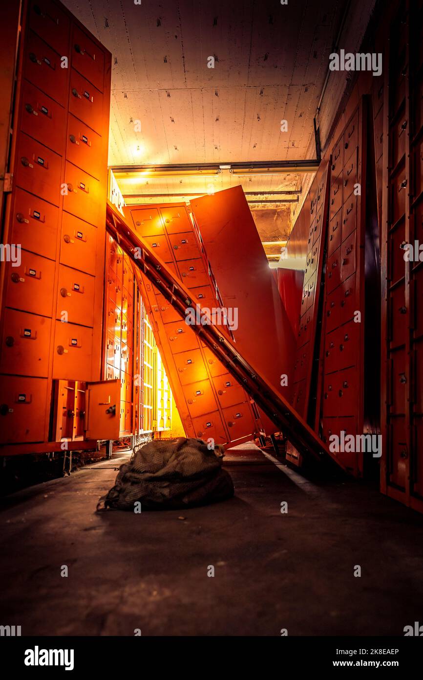 destroyed clothes lockers in an old mine. The sun shines through from ...