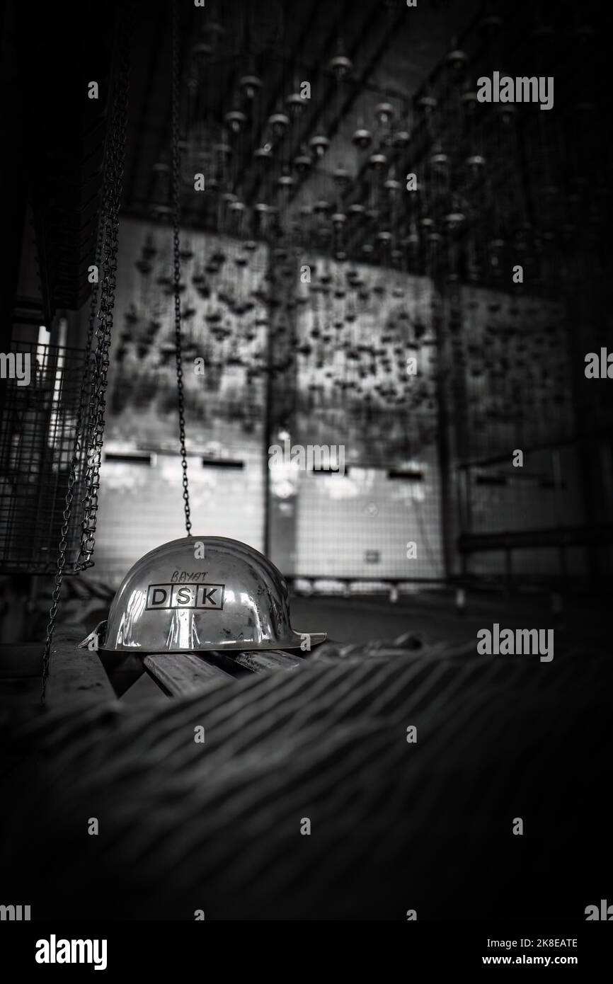 An old safety helmet on a bench Stock Photo - Alamy