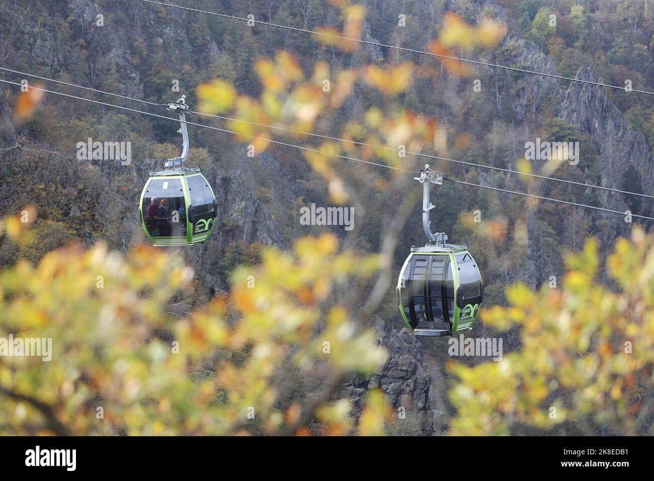 Thale, Germany. 23rd Oct, 2022. Gondolas of the cable car float above ...