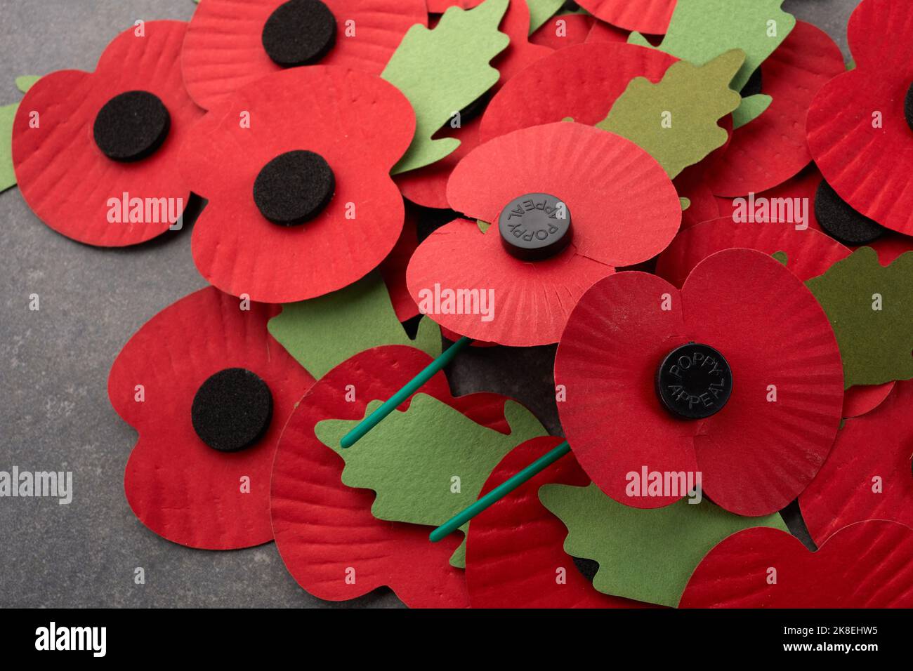 World War remembrance day. Red paper poppies on dark stone background ...