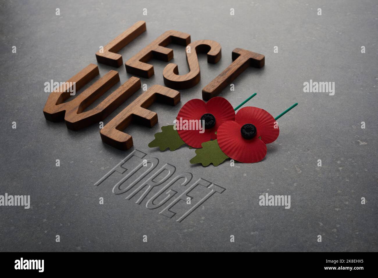 World War remembrance day. Lest we forget words and red paper poppies ...