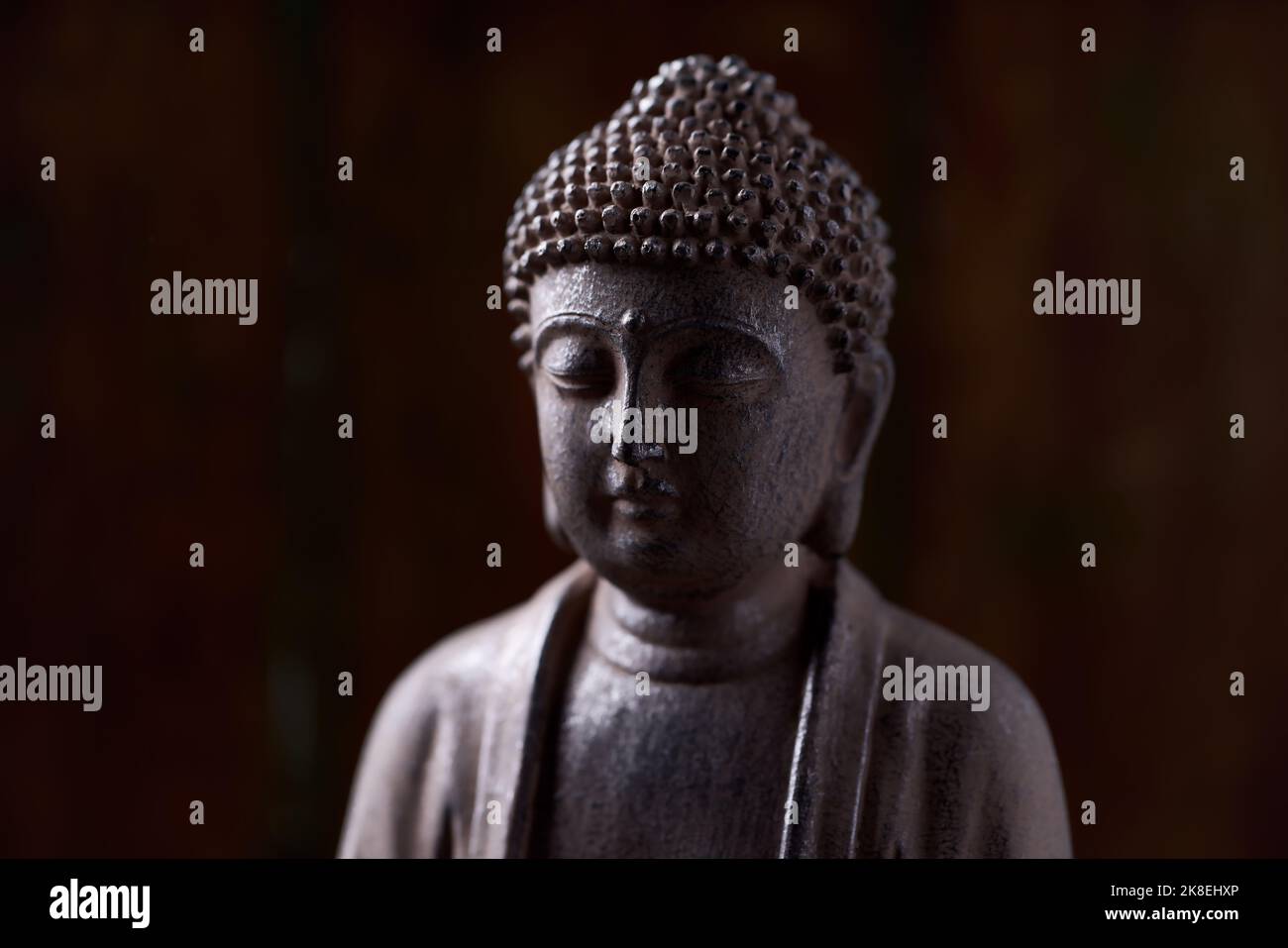 Meditating Buddha Statue on dark background. Soft focus. Close up. Copy ...