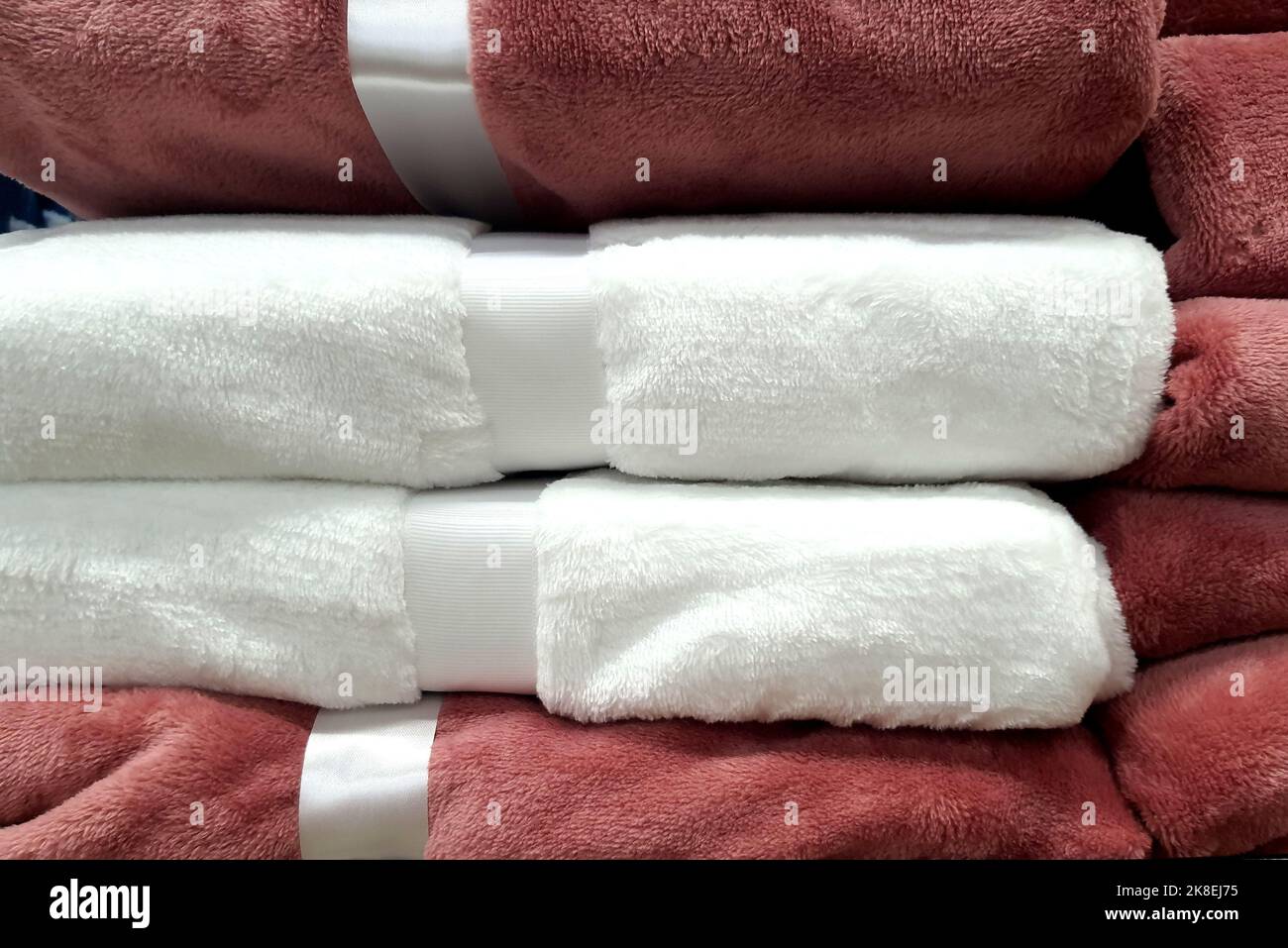 Stack of warm blankets, bedspreads, lies on store shelf. Household ...