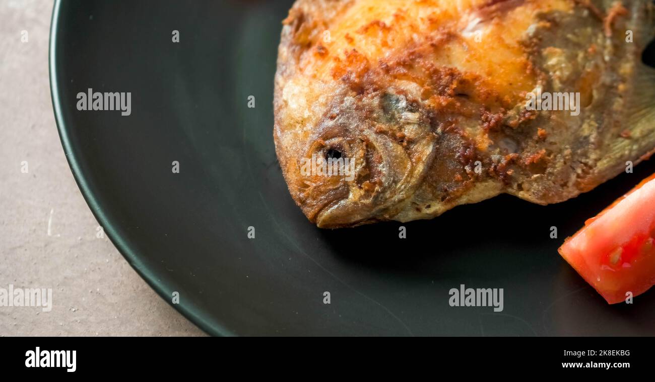 pomfret fish or ikan Bawal, that have been cooked or fryied well Stock ...