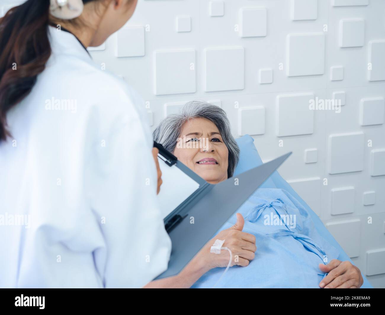 Smile Asian senior woman grey hair patient lying on bed, recovering ...
