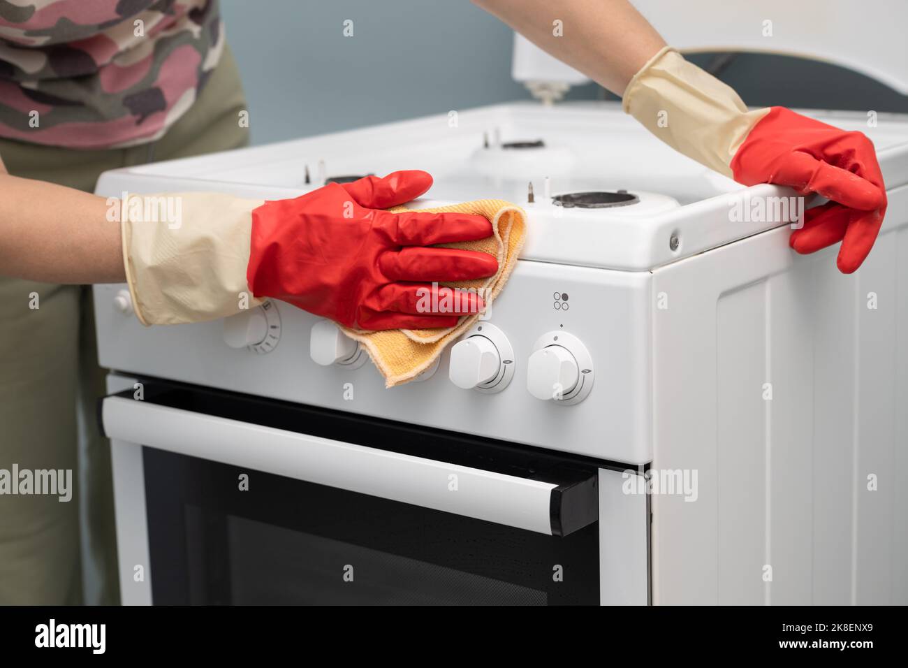 man washing a gas stove with a rag. hostess cleaning the kitchen Stock ...
