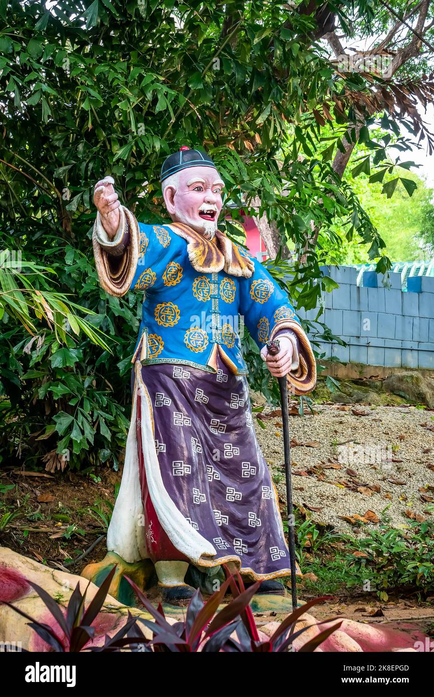 Traditional Chinese man leading the way at Haw Par Villa Theme Park ...
