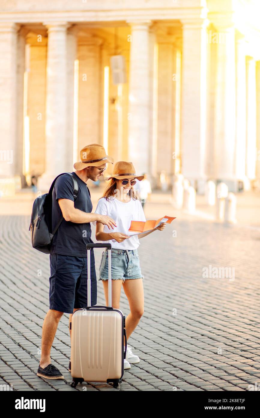 Happy tourists looking at a map. Couple of tourists on vacation in Rome ...