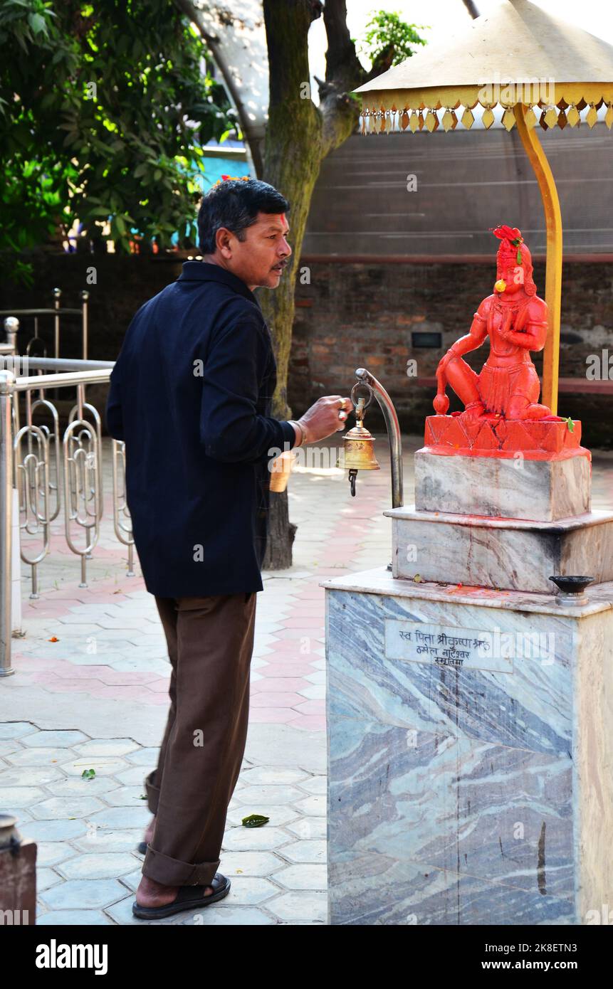 Nepali men people rite ritual and respect praying Mahadeva statue or ...