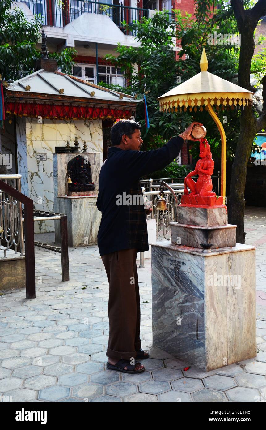 Nepali men people rite ritual and respect praying Mahadeva statue or ...