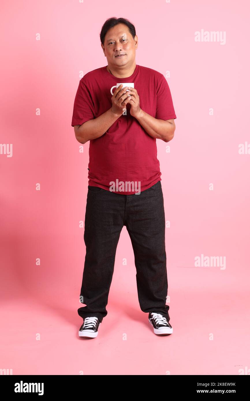 The 40s adult overweight Asian man standing on the pink background ...