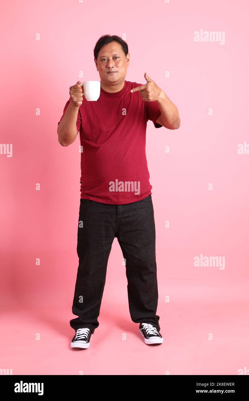The 40s adult overweight Asian man standing on the pink background ...