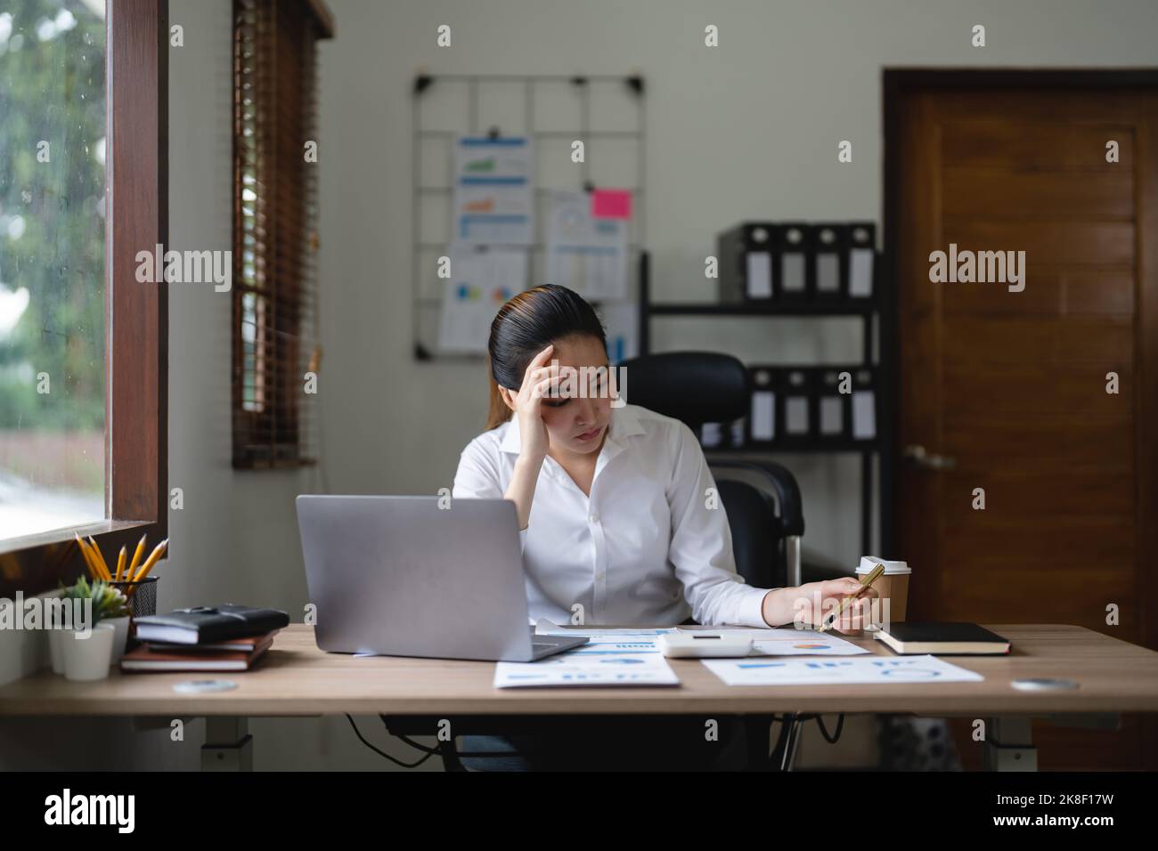 Tired asian business woman with headache at office, feeling sick at ...