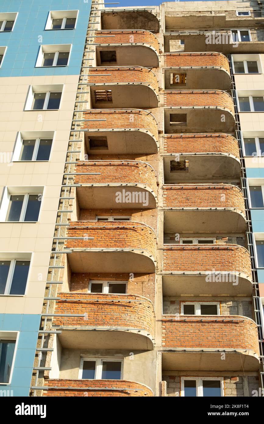 Balconies of building. House cladding. Construction of new residential ...